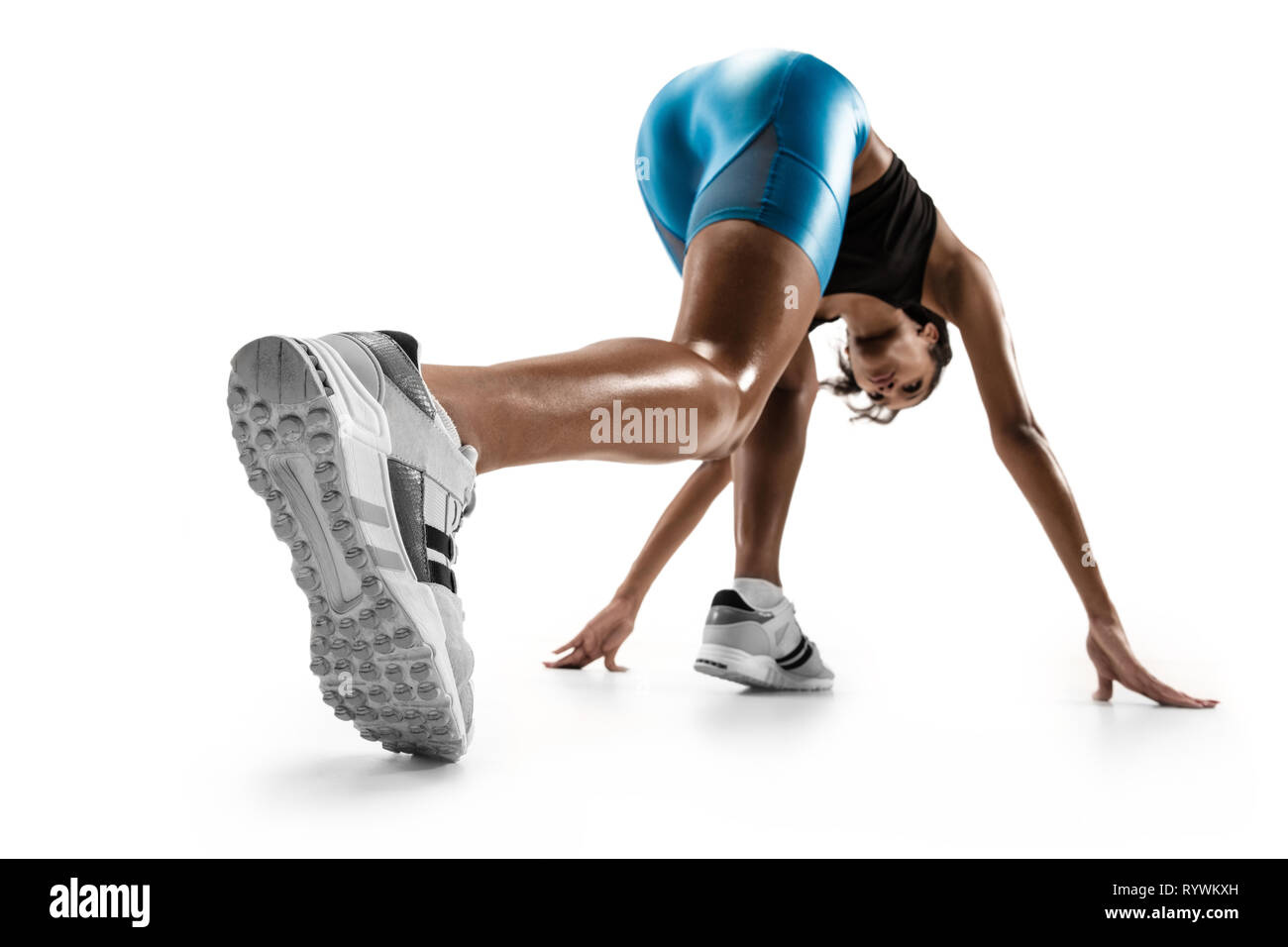 Young african woman preparing to start run isolated on white studio ...