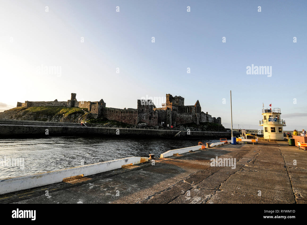 The ruins of St. German Cathedral within Peel castle on St Patrick's Isle connected by a ...