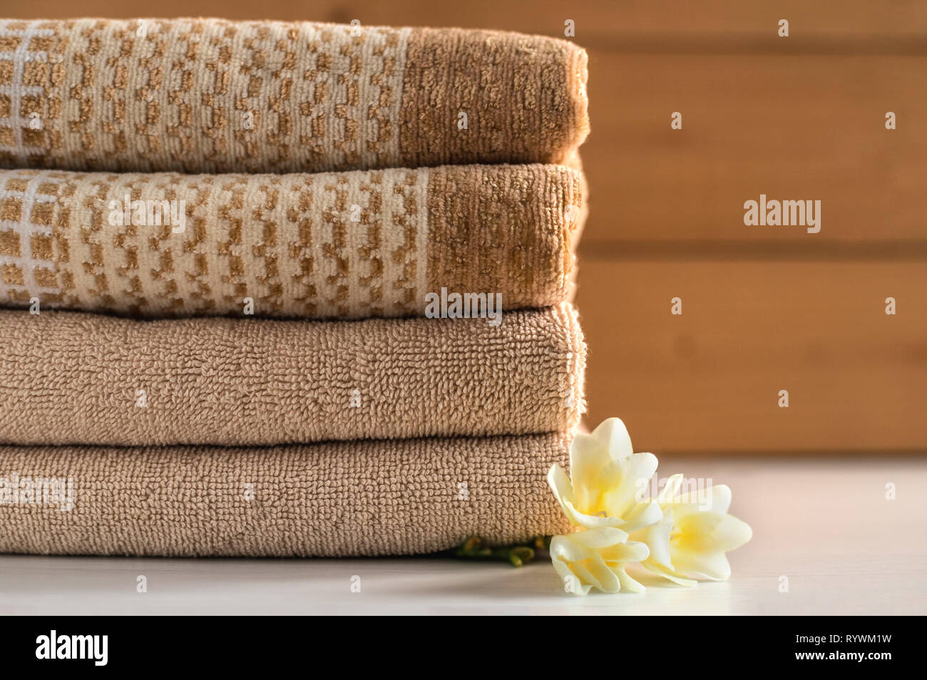 Stack of beige towels on wooden background Stock Photo - Alamy