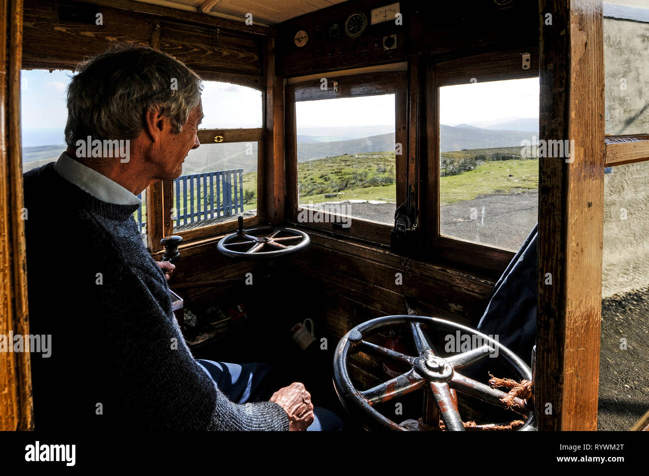 A tram driver in his cab at the controls of the 100 year old electric ...