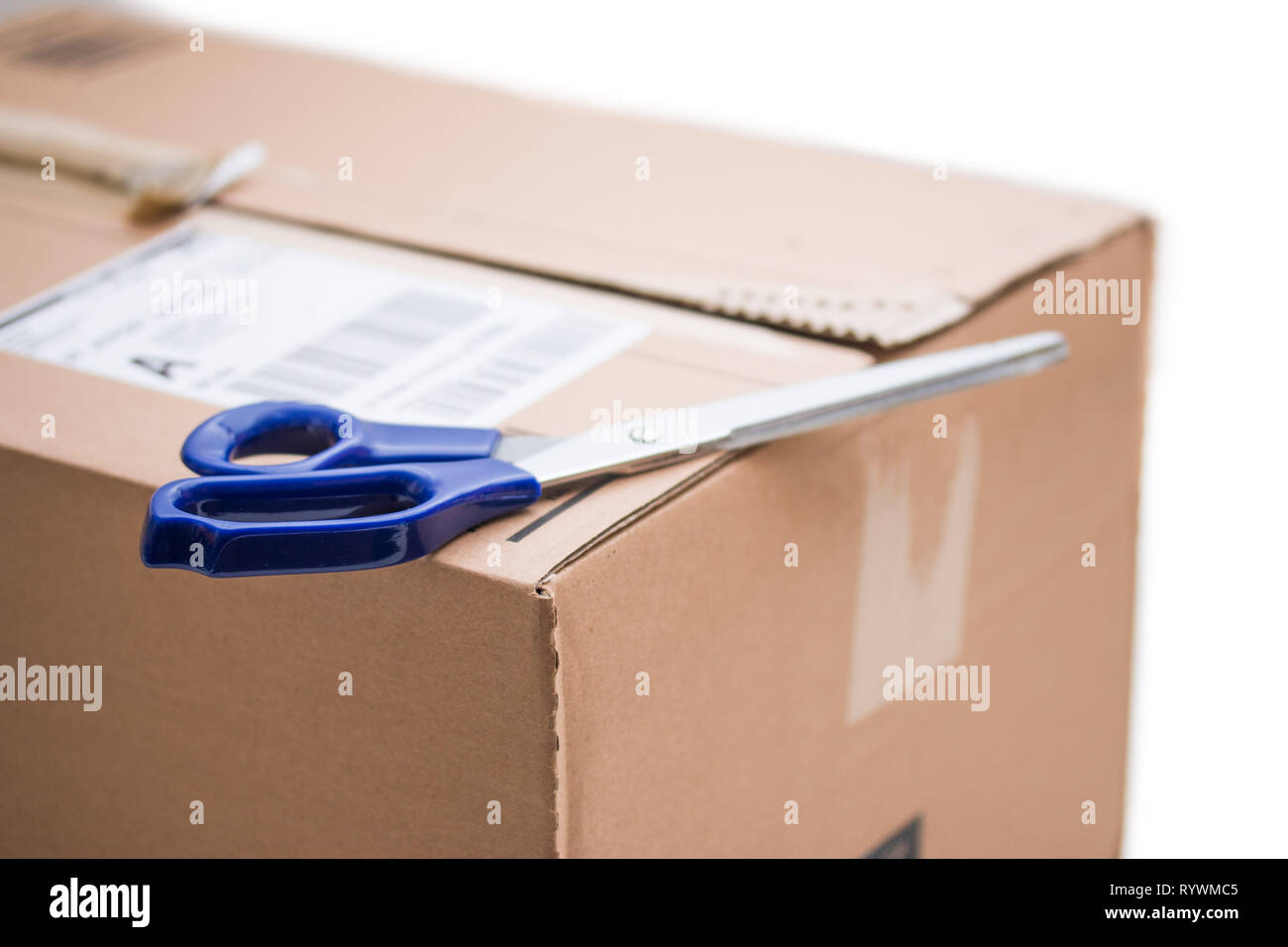 Shipping concept: Cardboard box and scissors Stock Photo - Alamy