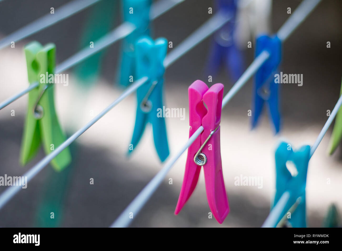 Clothespin clamp on rope, colourful, outdoors Stock Photo - Alamy