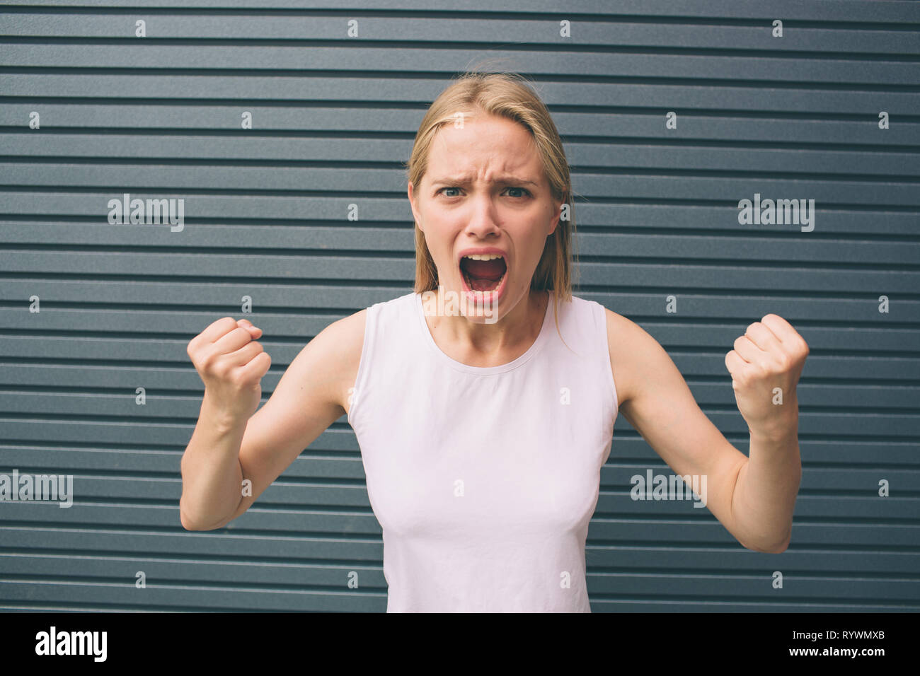 Beautiful blonde girl on the background , angry screaming woman ...