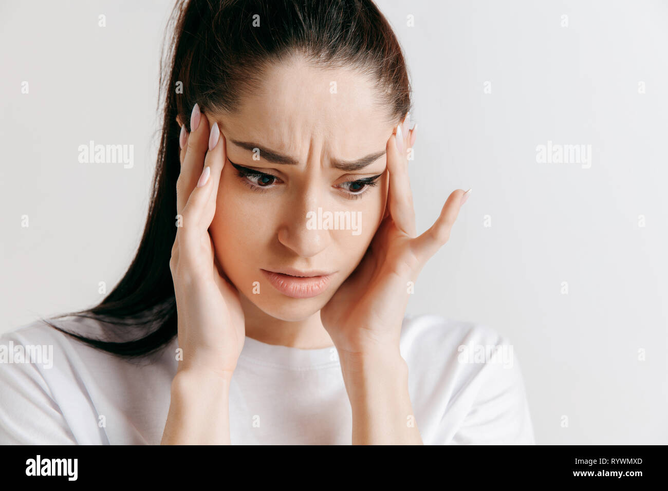 Woman having headache. Isolated on gray background. Businesswoman ...