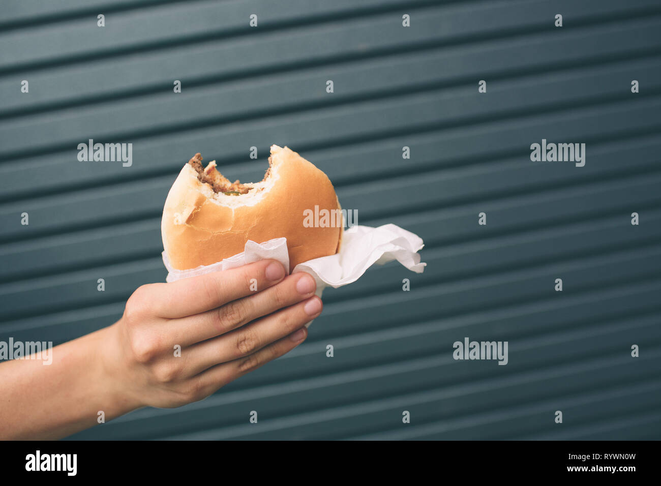 Eating hamburger. Delicious hamburger in the hands. Fastfood meal Stock ...