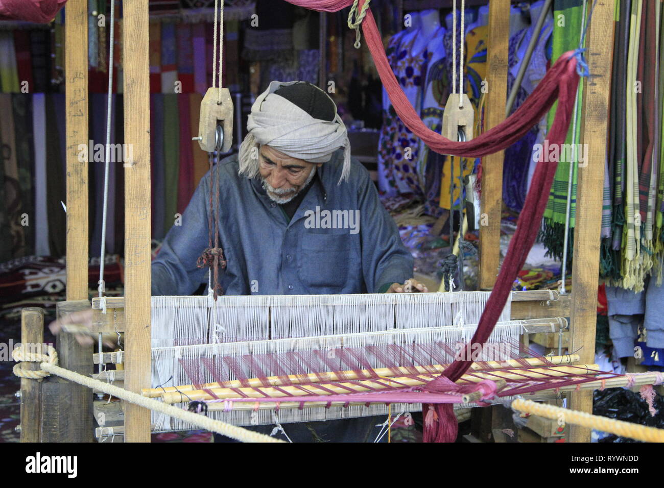 Man weaving textiles and scarves on a loom, Elephantine Island, Aswan ...