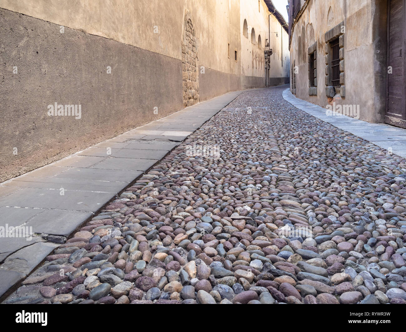 Travel to Italy - cobblestone pavement at medieval street Via Arena in ...