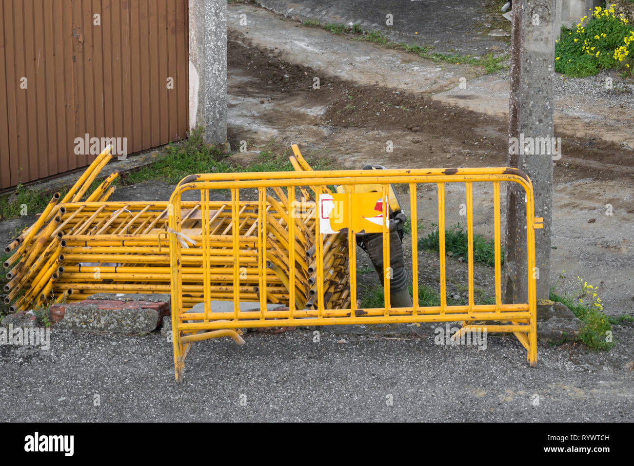Temporary yellow metal fences on the road Stock Photo - Alamy