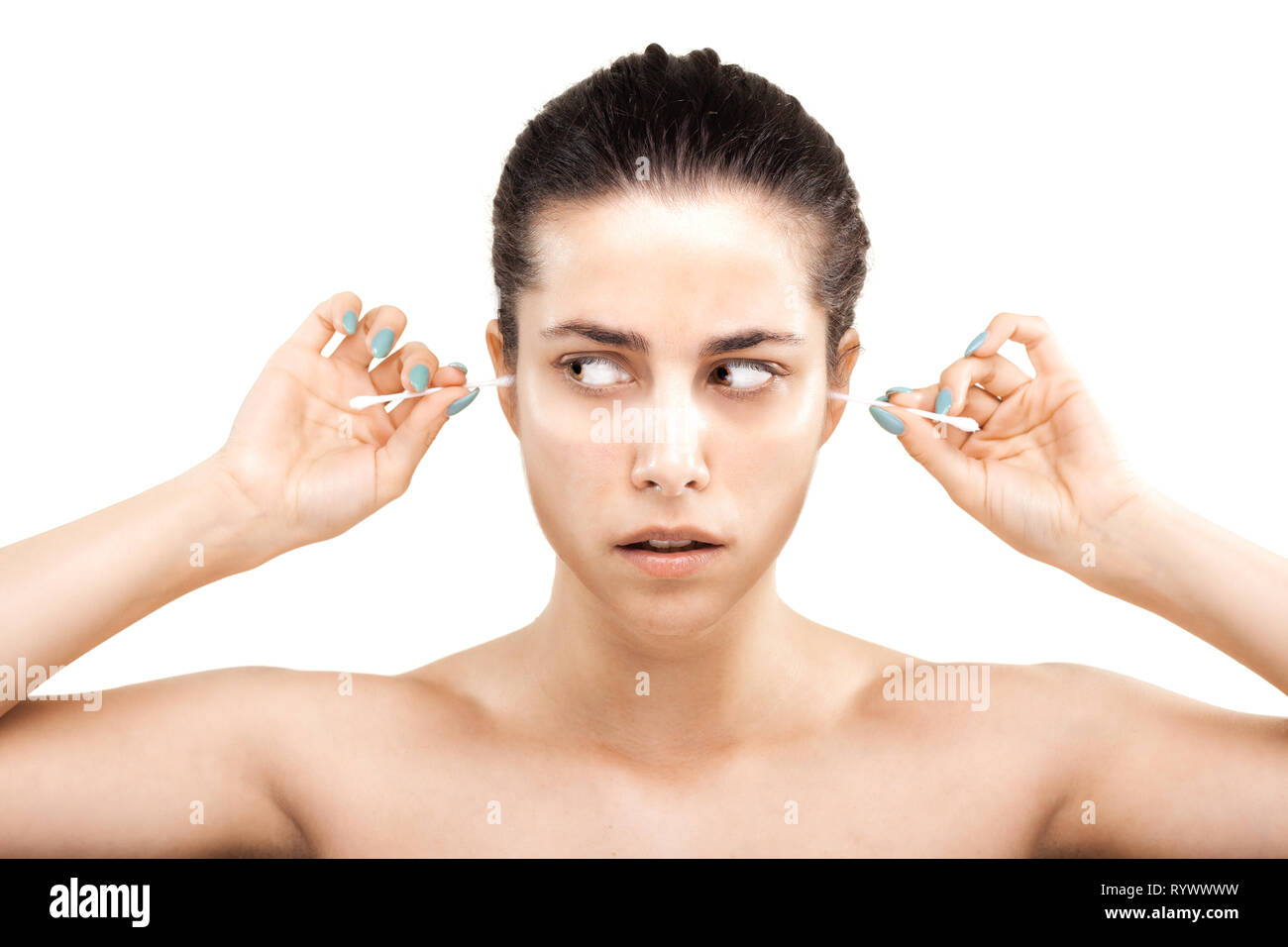 girl cleaning her ears with cotton sticks and making grimace Stock ...