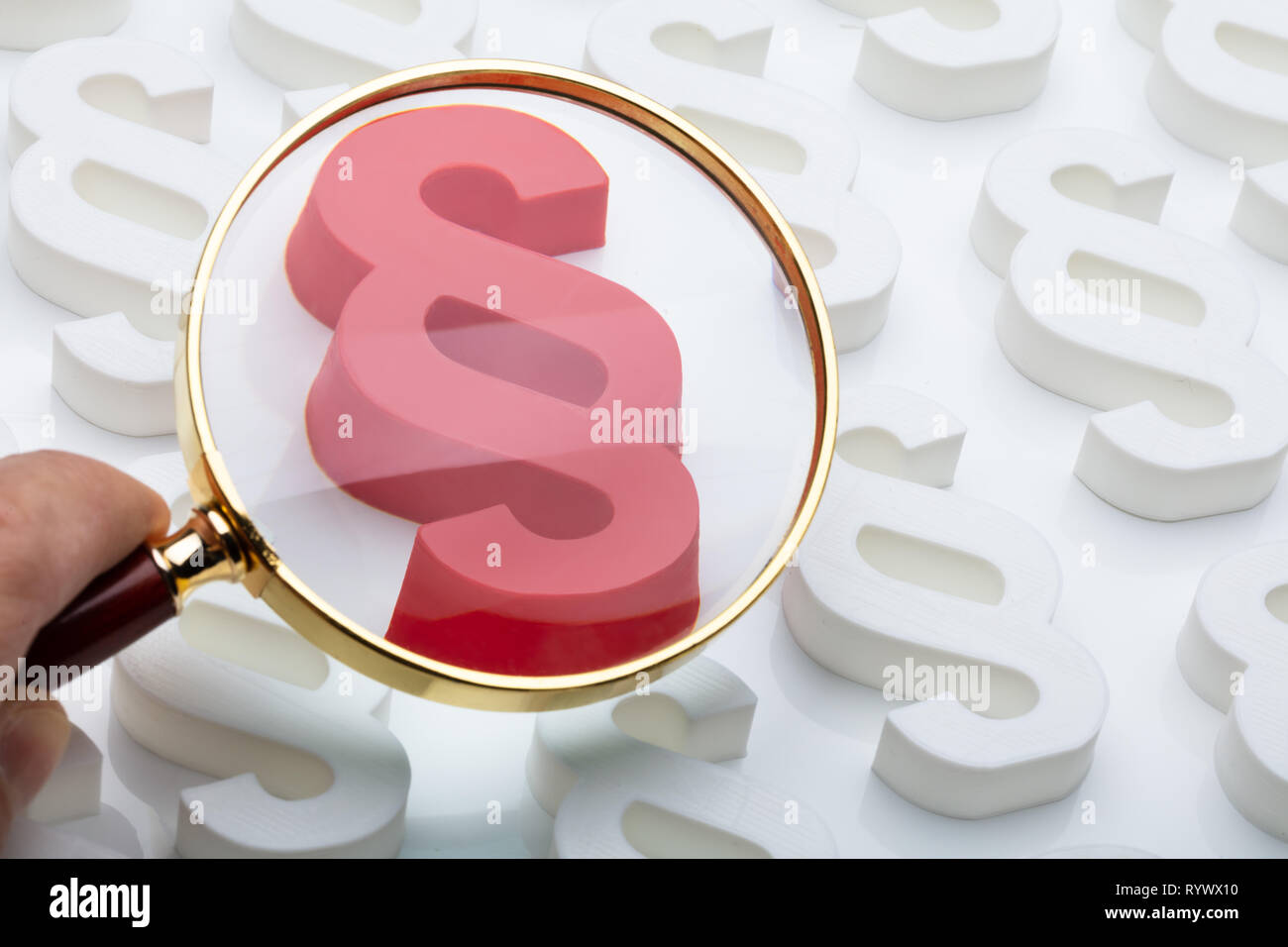 Close-up Of A Person Looking At Red Paragraph Symbol Through Magnifying ...