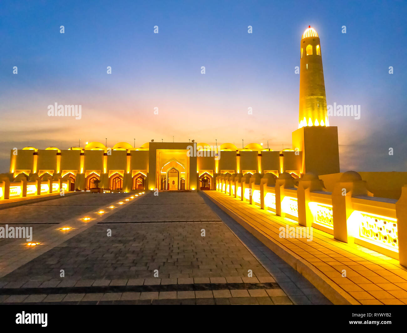 Lighted path towards State Grand Mosque illuminated at night in Doha ...