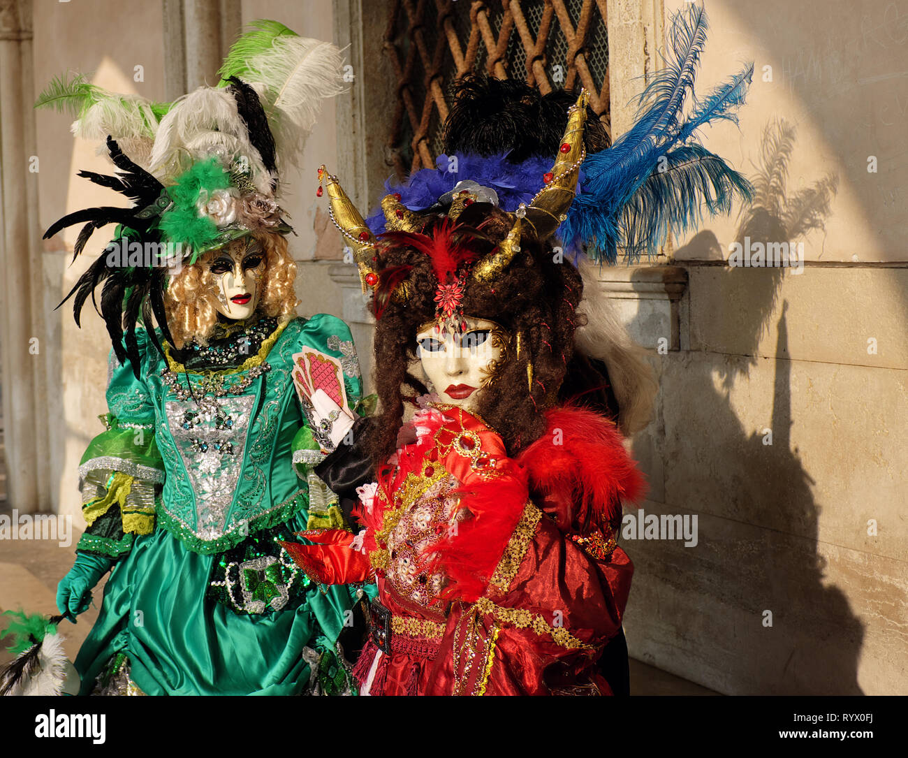 People dressed in traditional masks and costumes for Venice Carnival ...