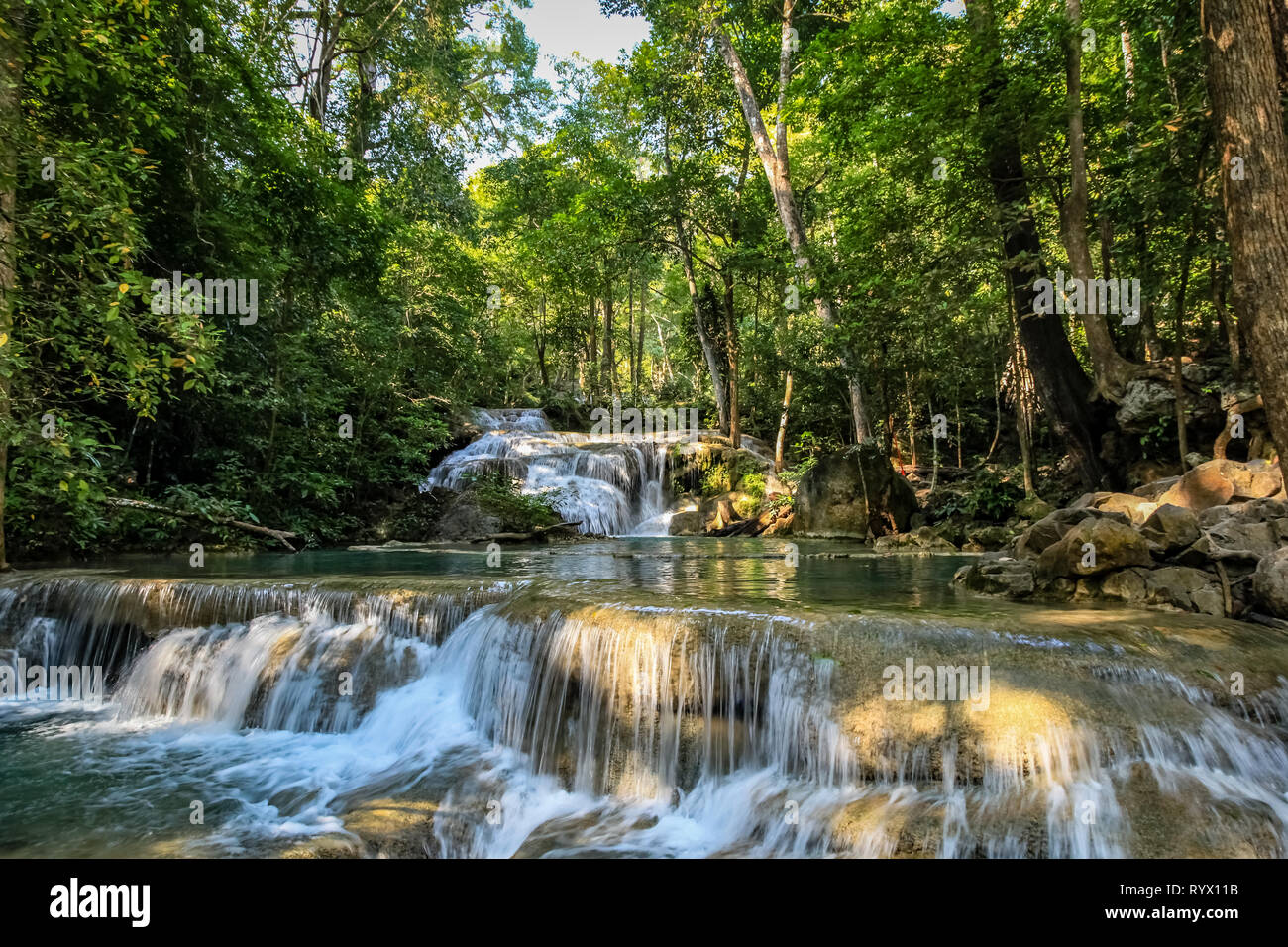 A series of beautiful short waterfalls and flat pools in the dense ...