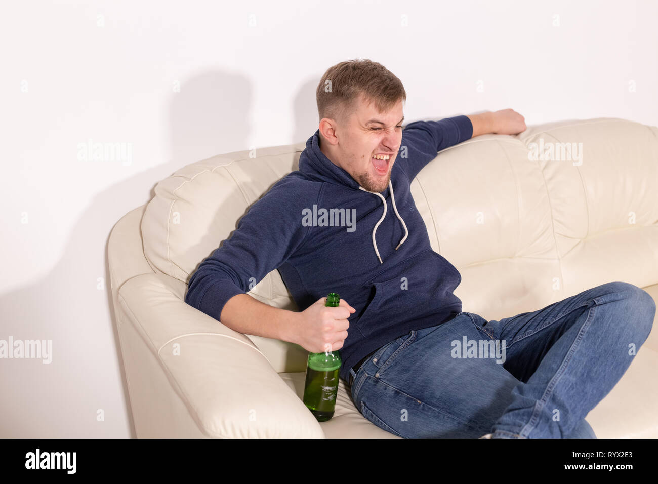 Depression and alcoholism concept - aggressive young man sitting on a ...