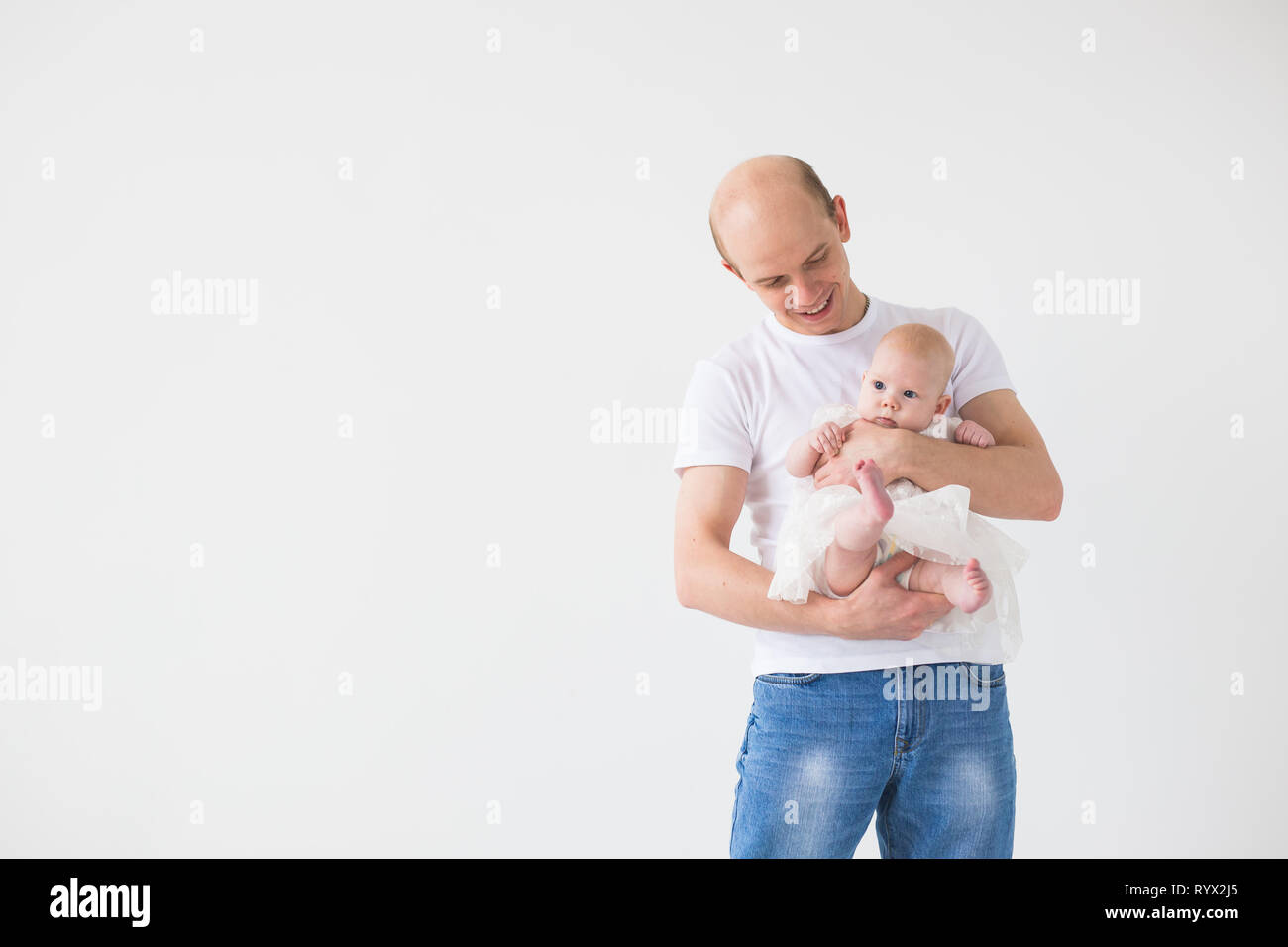 Parenting, family and fatherhood concept - Bald father hugging his ...