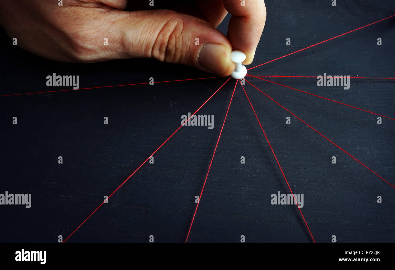 Hand holding pin with red thread. Internal communications and ...