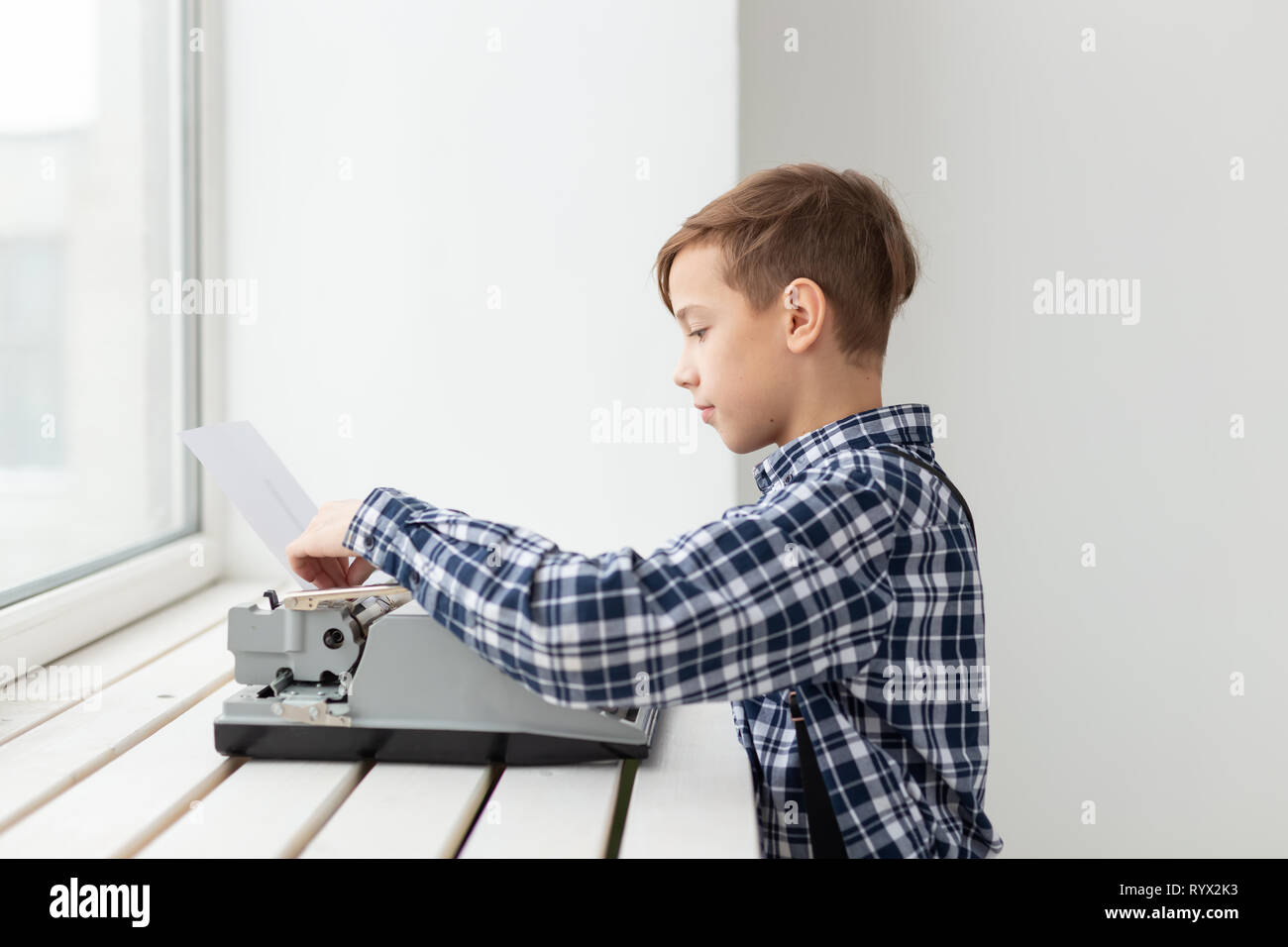 World day of the writer concept - Boy with an old typewriter over ...
