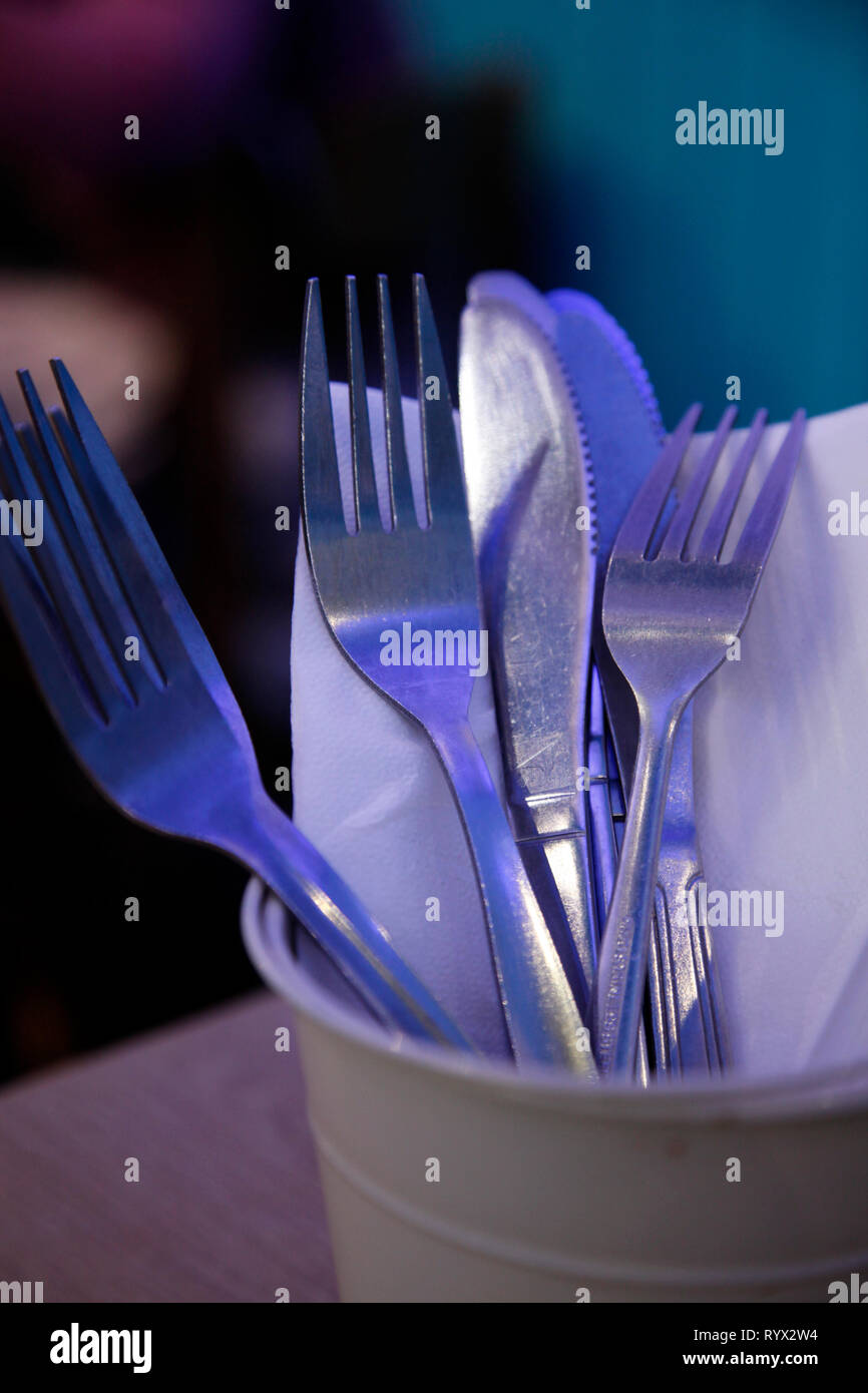 Pot containing metal cutlery in a fish and chip shop Stock Photo - Alamy