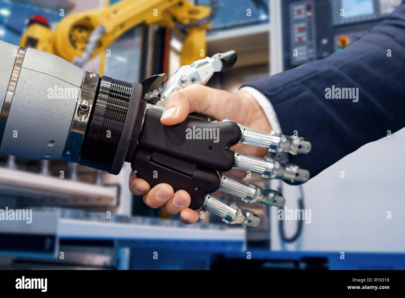 Hand of a businessman shaking hands with a Android robot. The concept ...