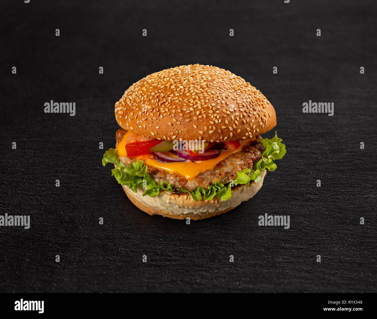 Delicious grilled burger on black slate background Stock Photo - Alamy