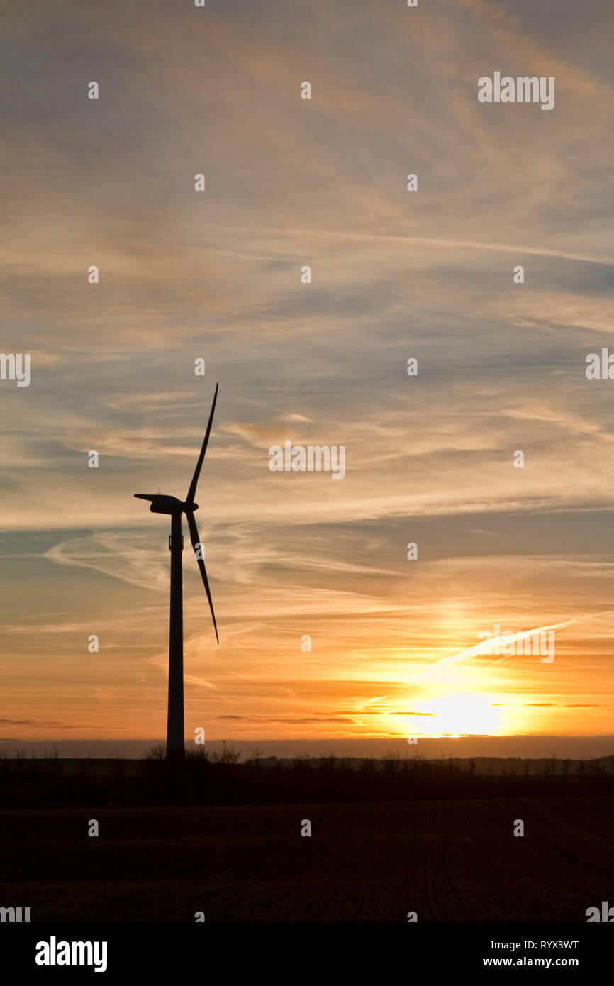 Wind turbine in the sunset. Can be used as background Stock Photo - Alamy