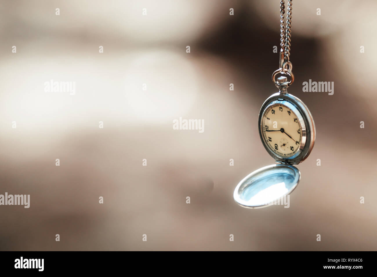 retro clock on a rope on a beautiful background Stock Photo - Alamy