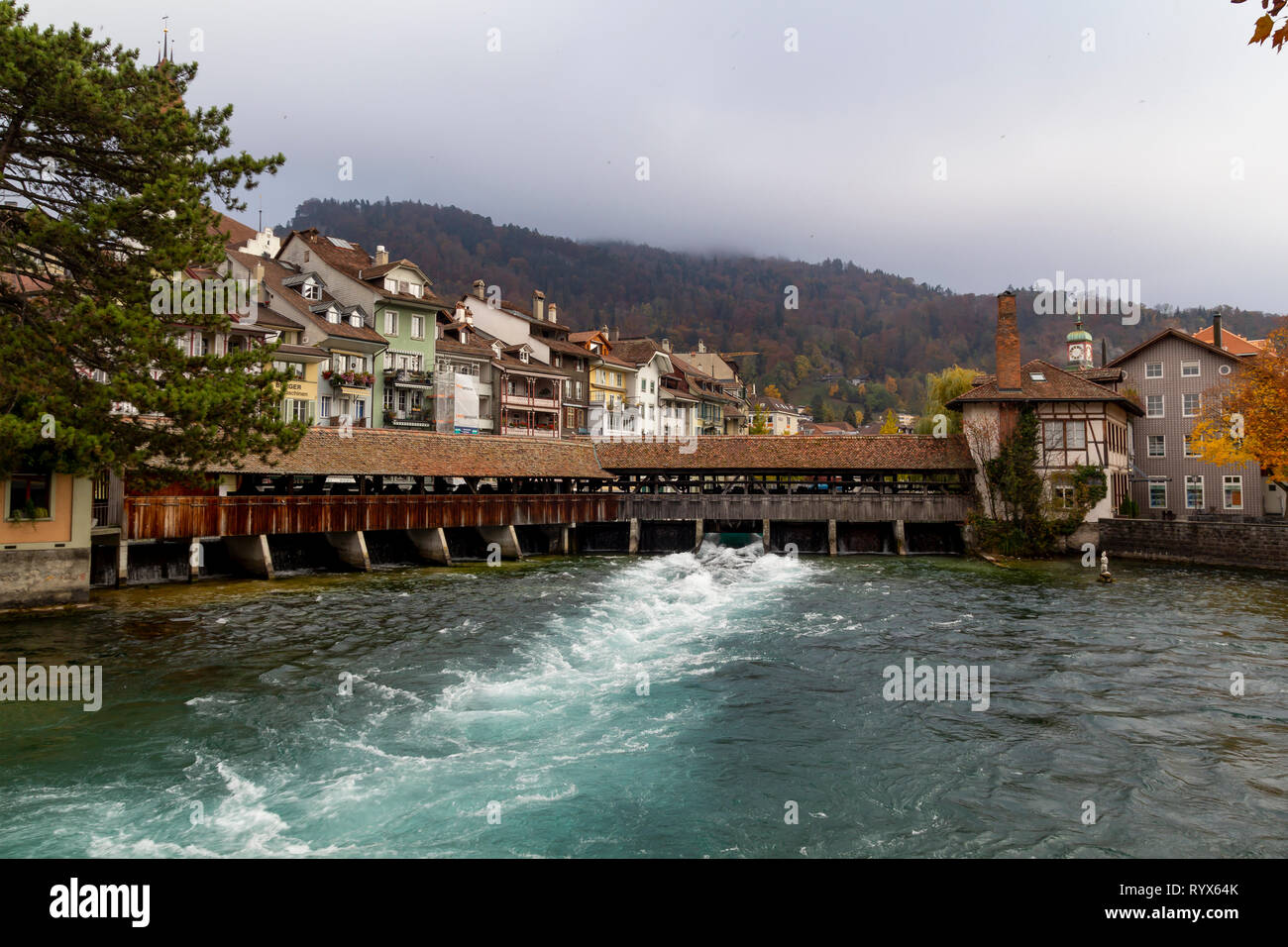 City view of Thun, with old and historical houses next to river Aare ...