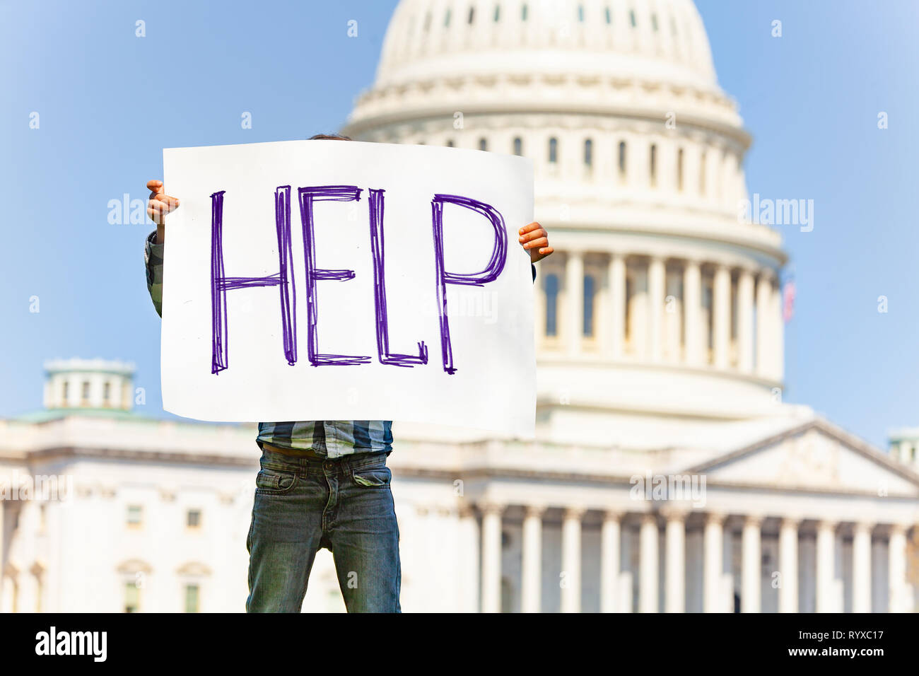 Child boy protest in front of the USA capitol in Washington holding ...