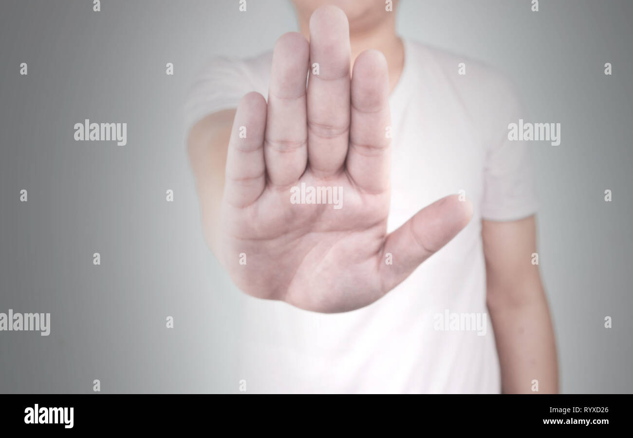 Handsome Asian young men Wearing a t-shirt hand show stop sign isolated ...