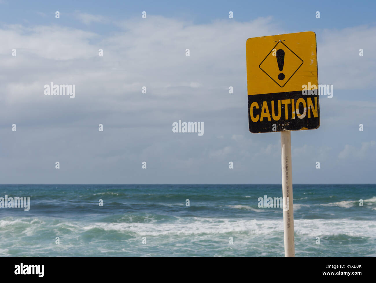 Yellow caution sign at the beach due to rough surf conditions Stock ...