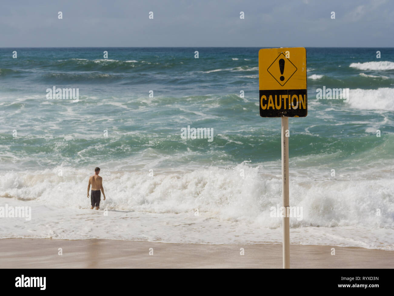 Yellow caution sign at the beach due to rough surf conditions Stock ...