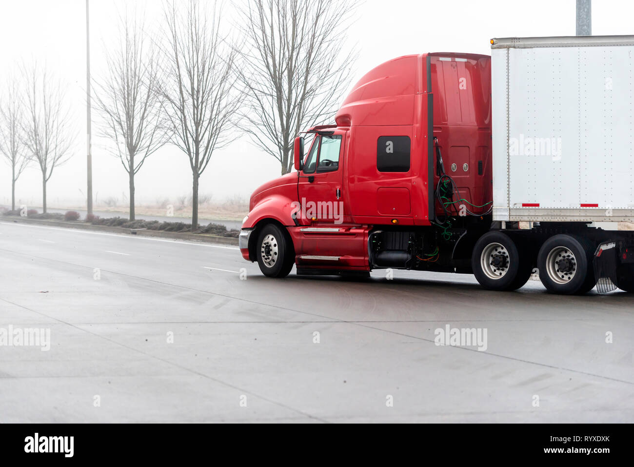 Big rig American classic red semi truck with dry van semi trailer ...