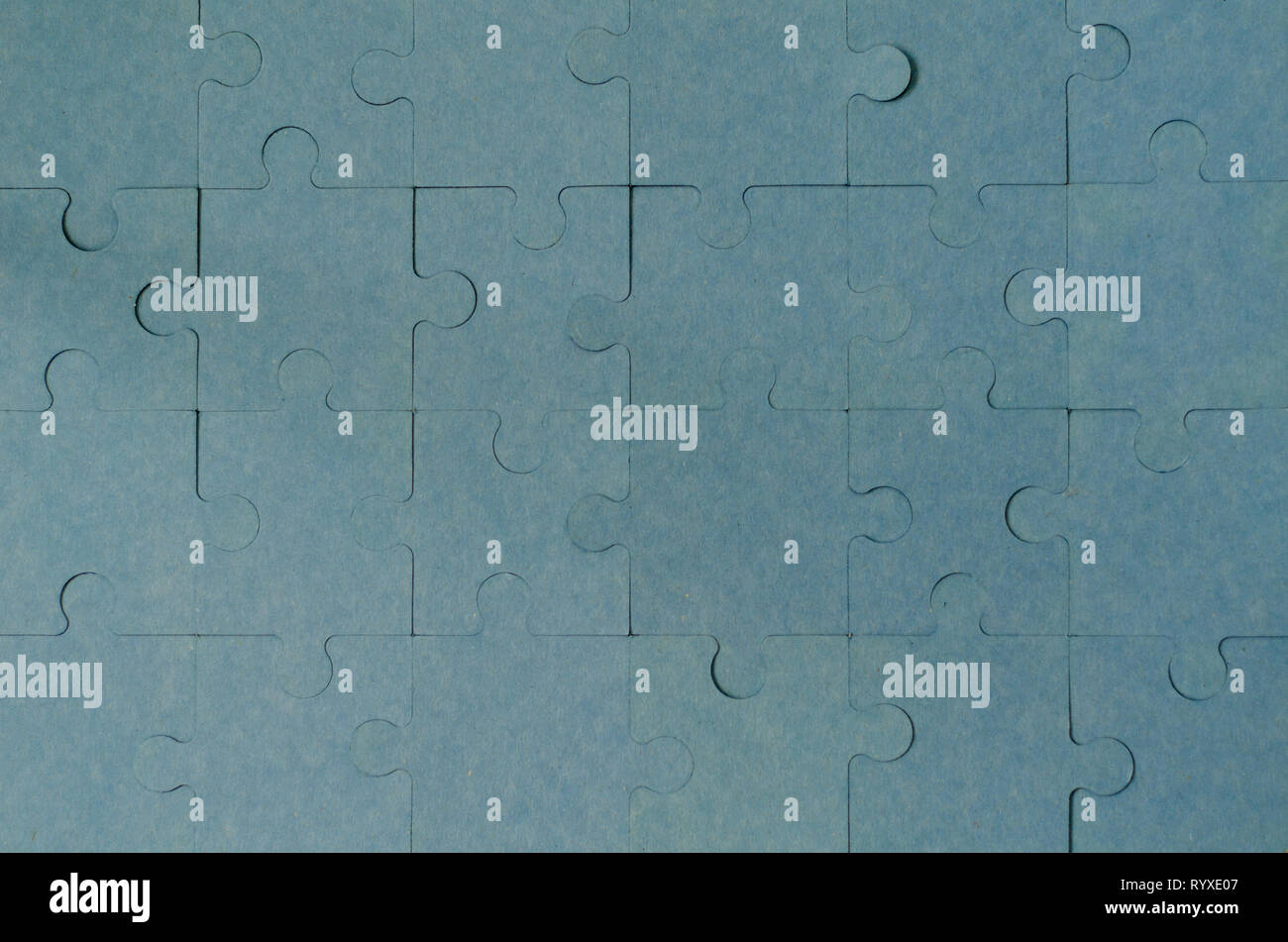 Finished blue jigsaw puzzle with copy space. Business strategy teamwork ...