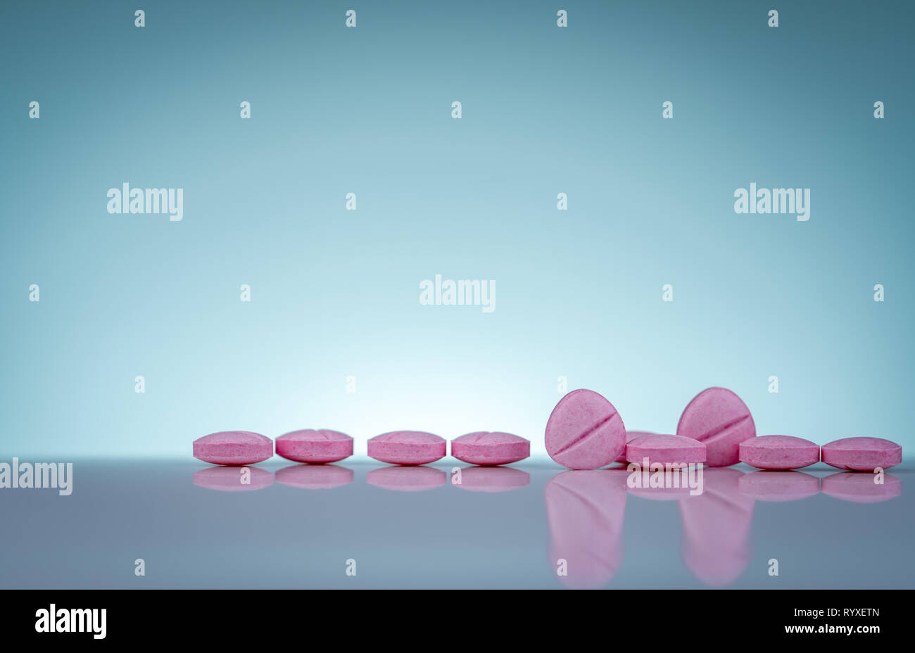 Pink tablets pills with shadow on gradient background. Pharmaceutical ...