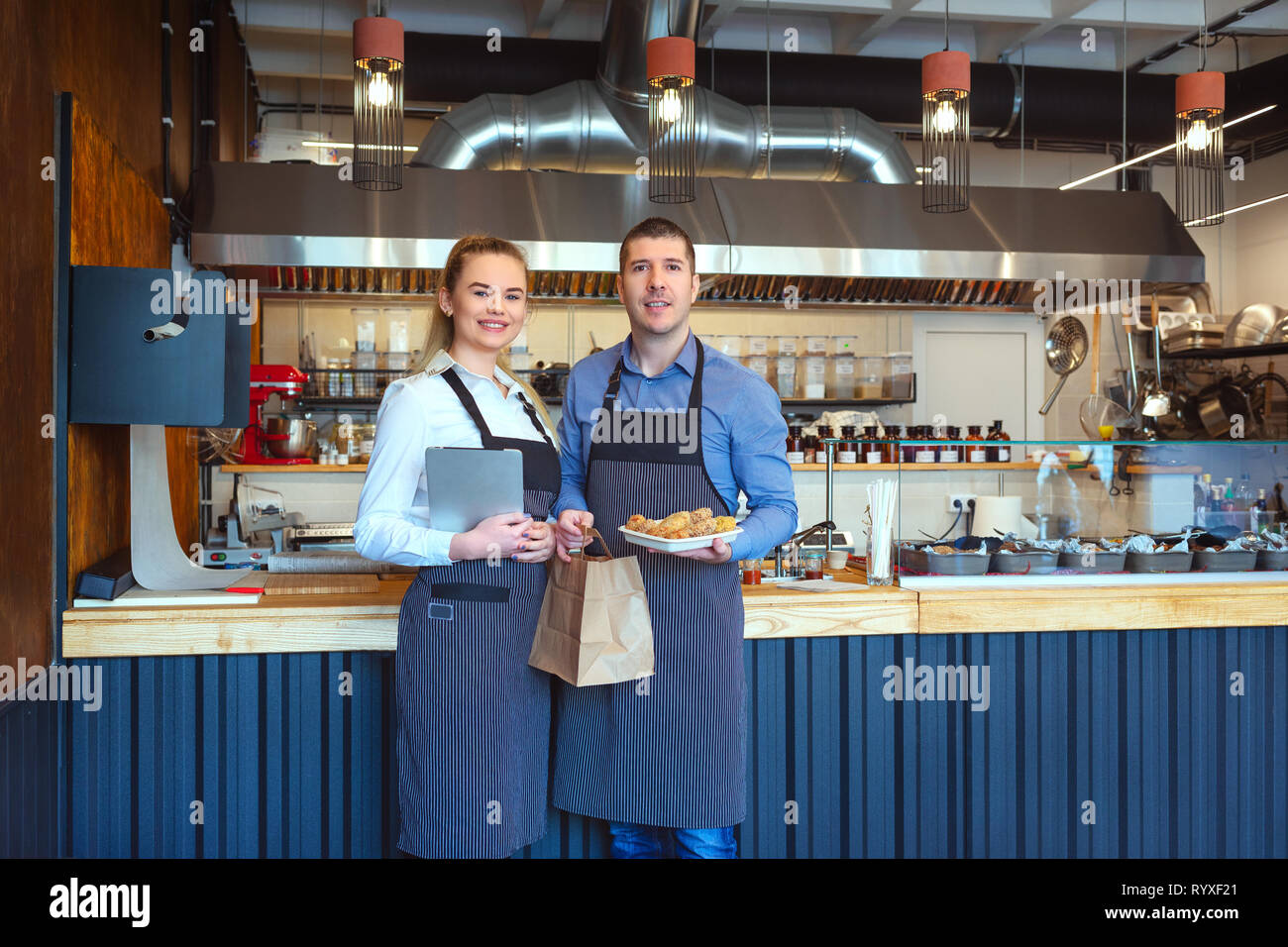 Catering service and home delivery with small restaurant owners holding ...