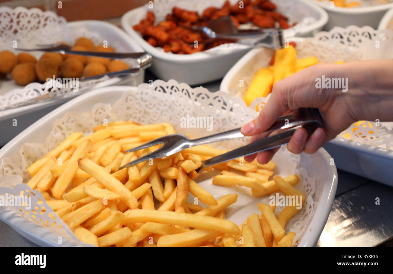 tray with many yellow hot fries in the self-service restaurant Stock ...