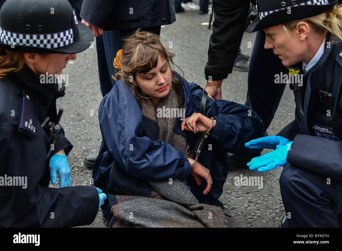 London, UK. 15th Mar, 2019. A student is arrested on Westminster Bridge ...