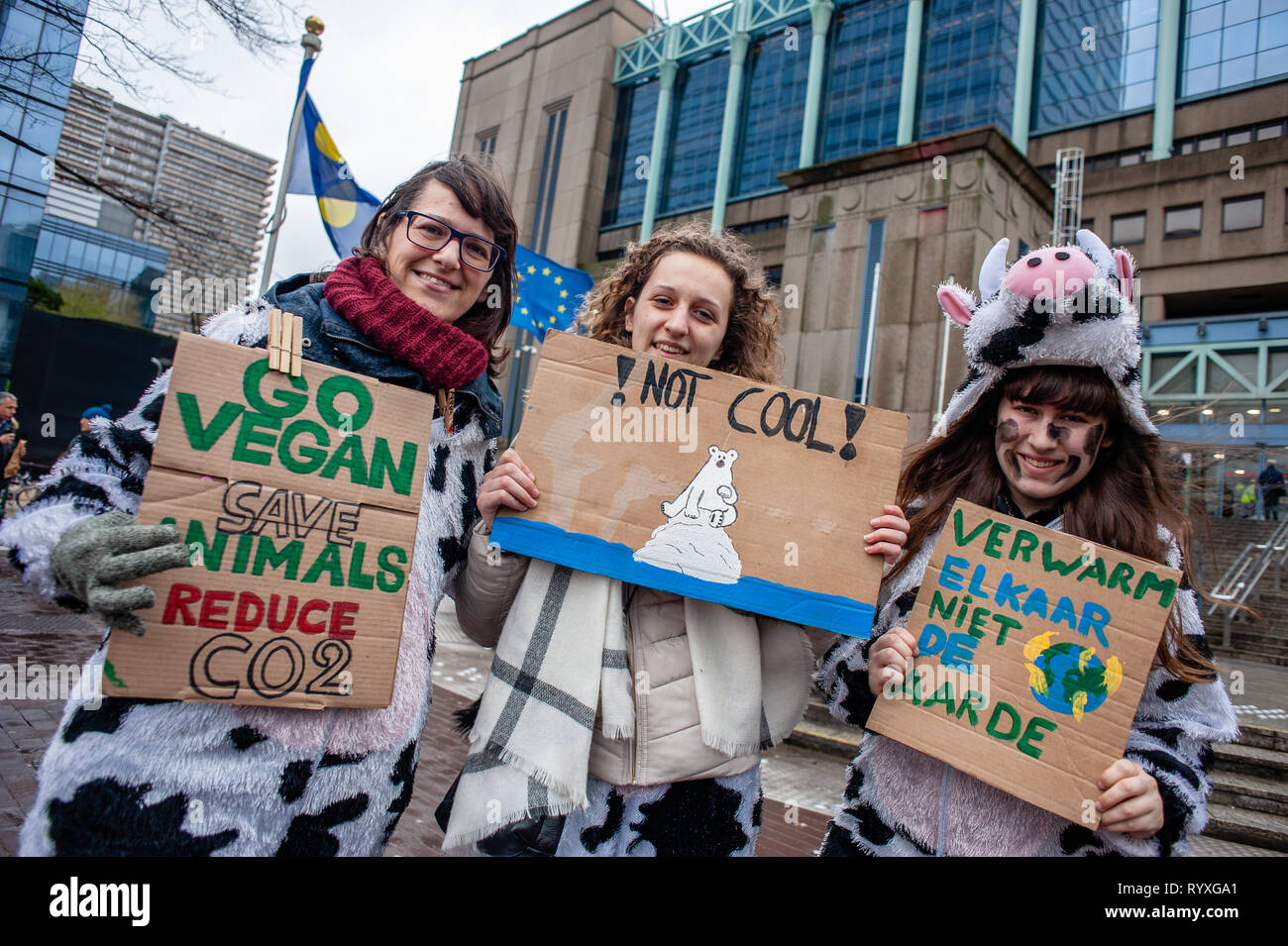 Three women are seen holding placards during the Global climate strike ...