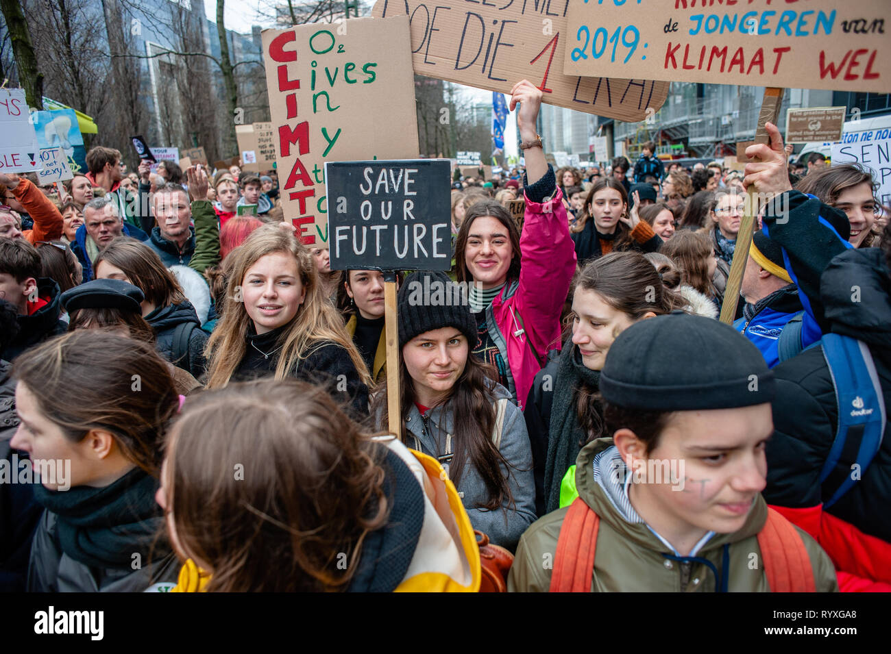 A group of people are seen holding placards while shouting slogans ...