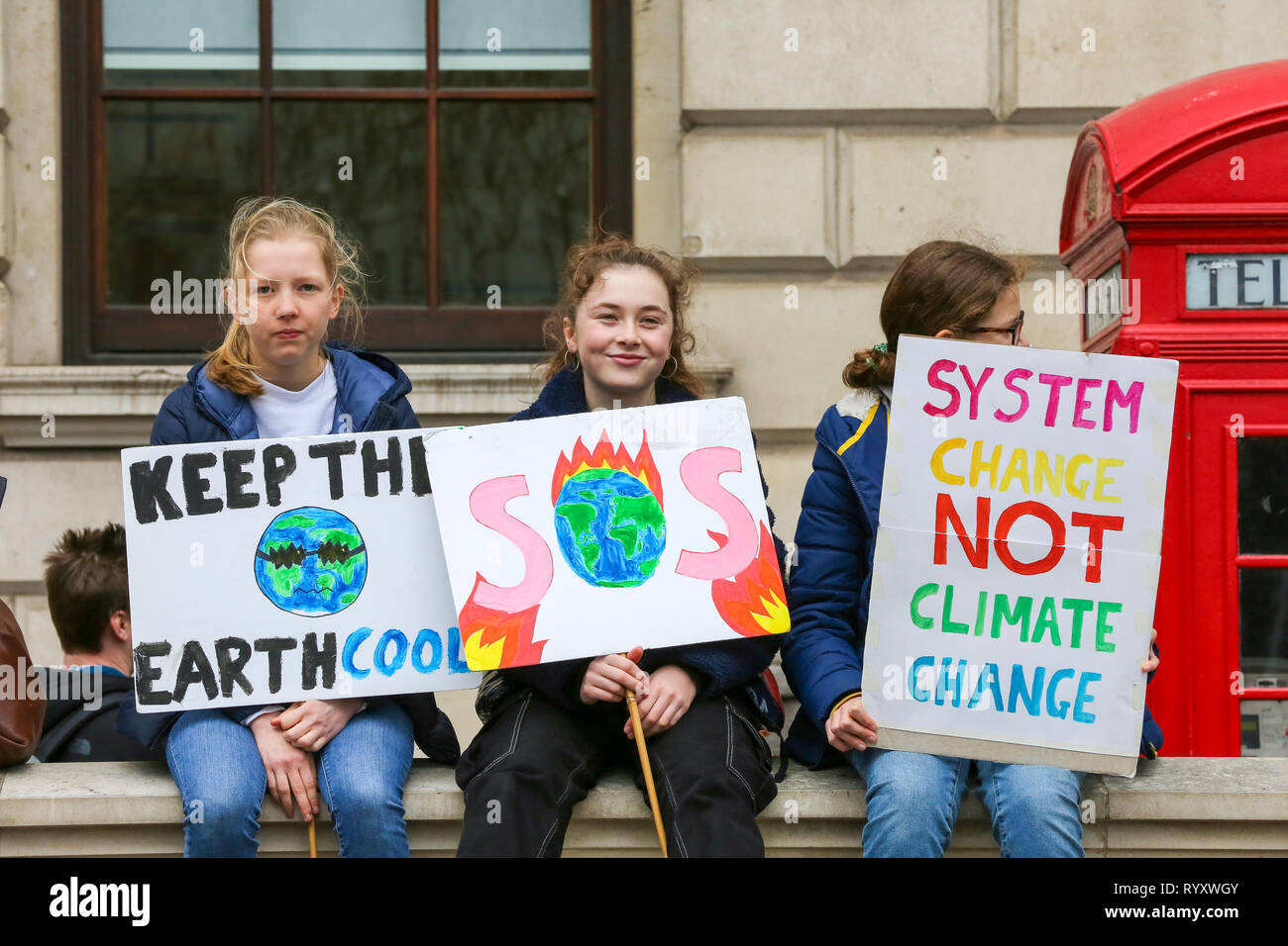 Students are seen holding placards during a climate change protest in ...