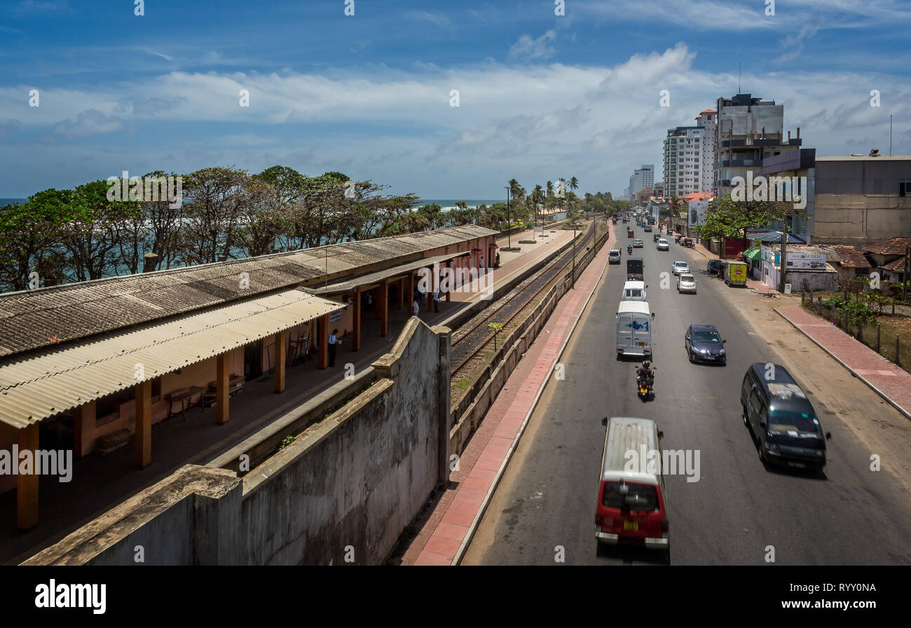 Busy street in Colombo running alongside railway station and coast in ...