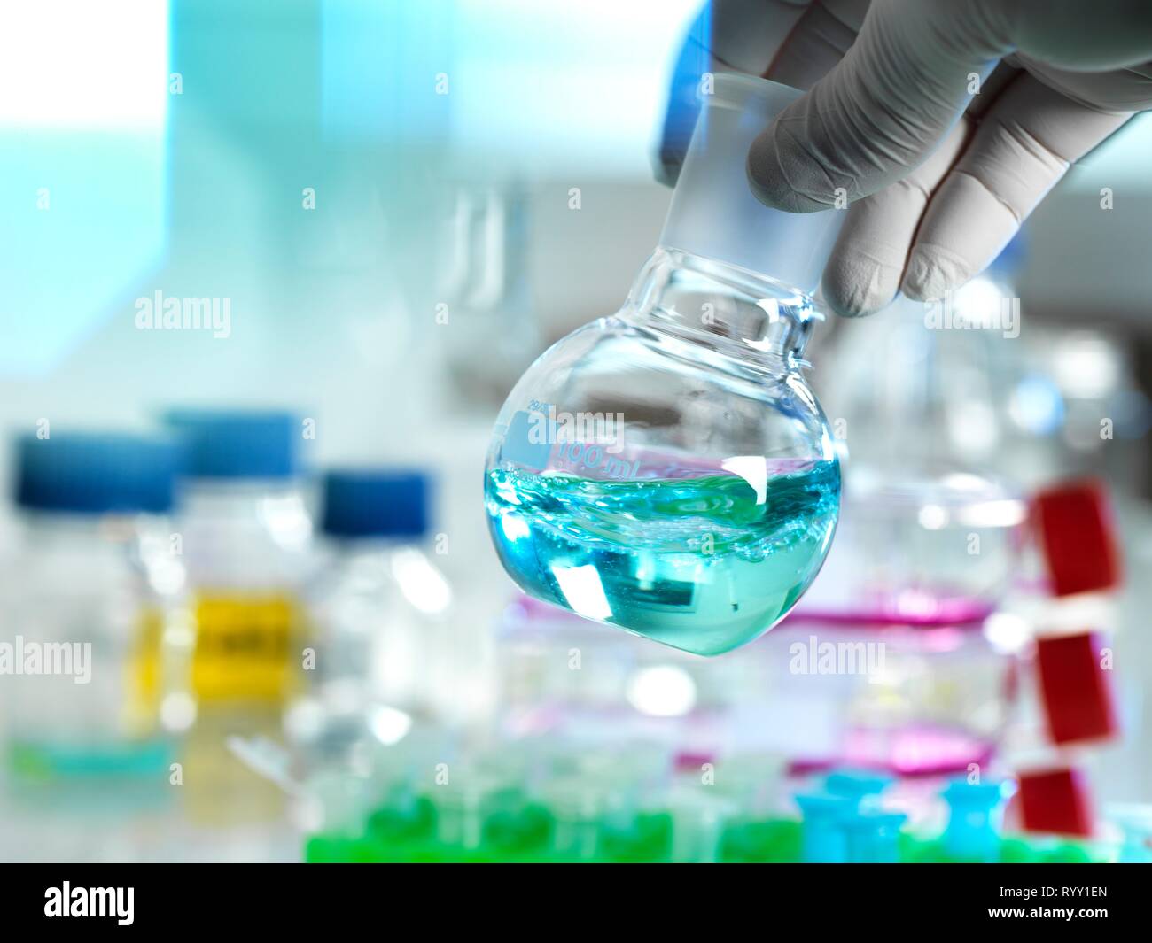 Scientist mixing and preparing a chemical solution during a experiment ...