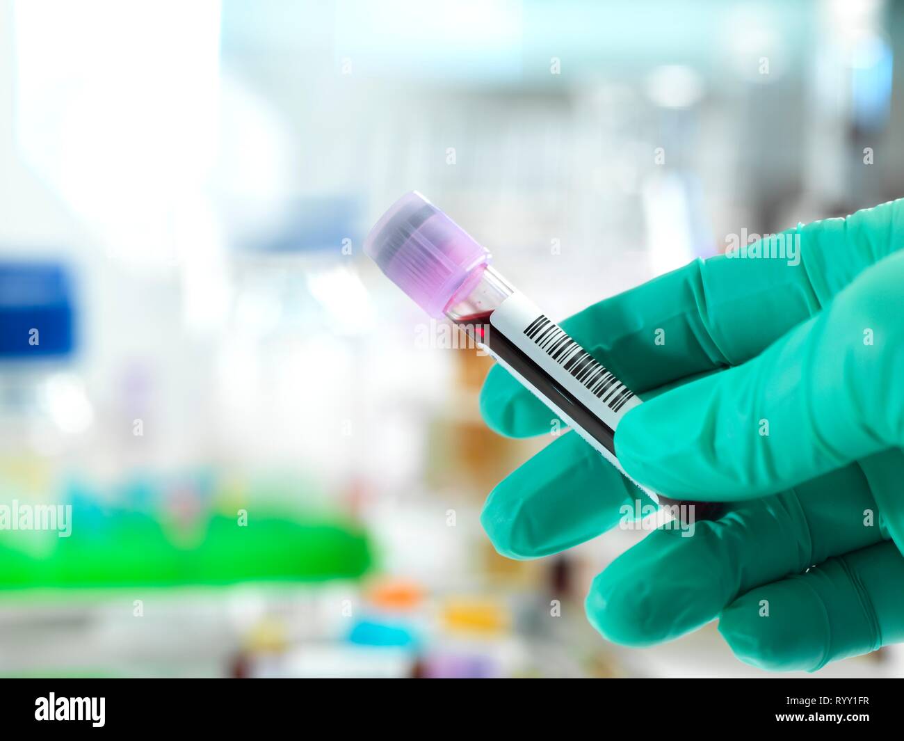 Technician holding a blood sample ready for testing with other human ...