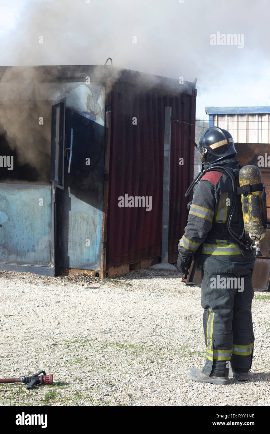 Firefighter putting out fire training station extinguisher backdraft ...