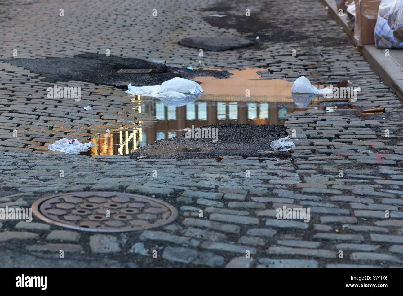 Broken cobblestones and pavement in New York City Stock Photo - Alamy