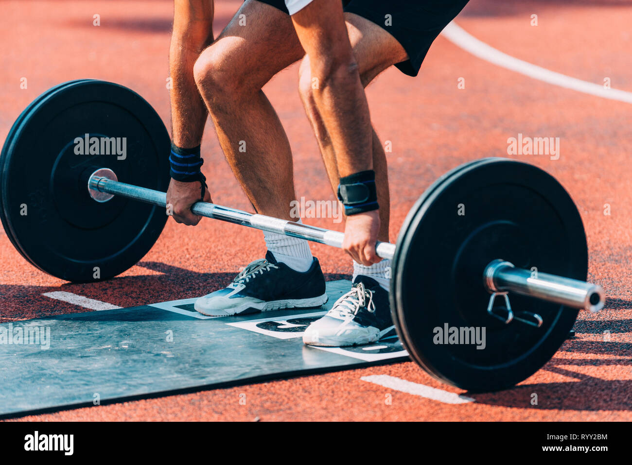 Man lifting barbell Stock Photo - Alamy