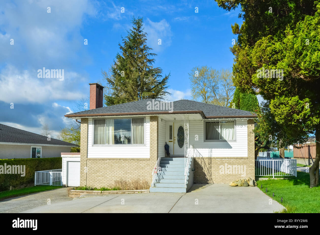 Modest family house with garage. Residential house on blue sky ...