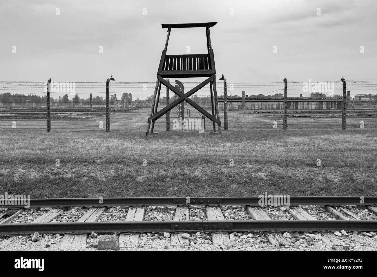 A guard tower and barbed wire fences in the Birkenau Auschwitz II ...