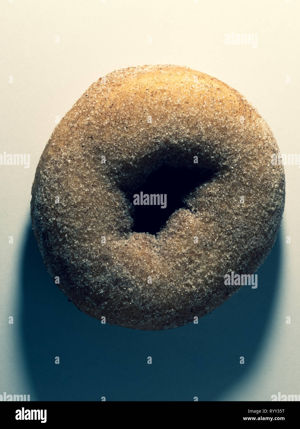 Doughnut closeup with heavy shadow Stock Photo - Alamy