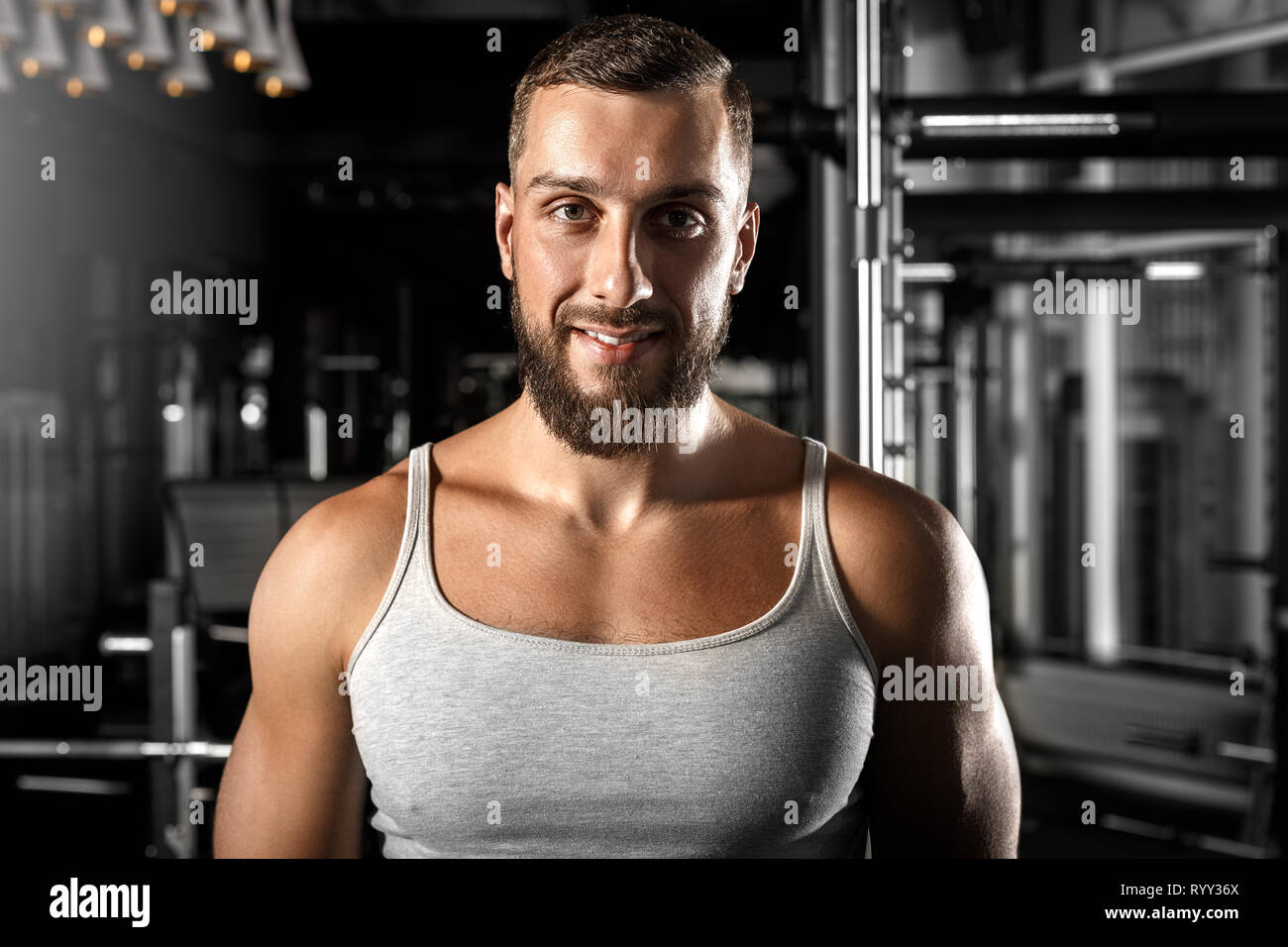 Bodybuilding. Bearded man standing at gym smiling happy to camera close ...